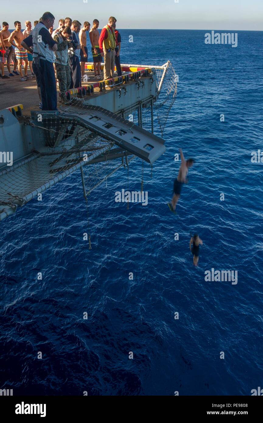 PACIFIC OCEAN (Nov. 15, 2015) Sailors and Marines jump off an aircraft ...