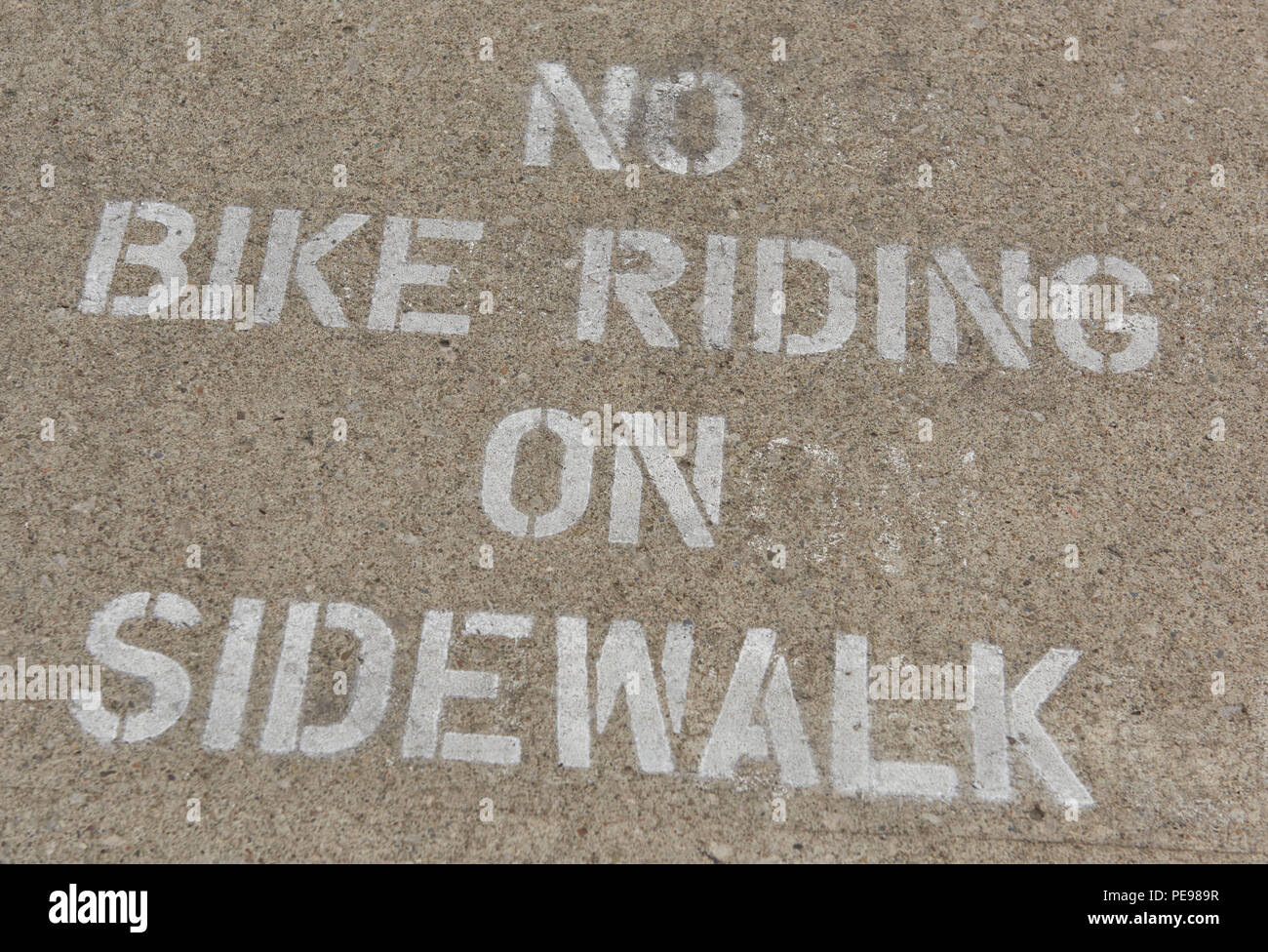 sidewalk warning of no bike riding Stock Photo - Alamy