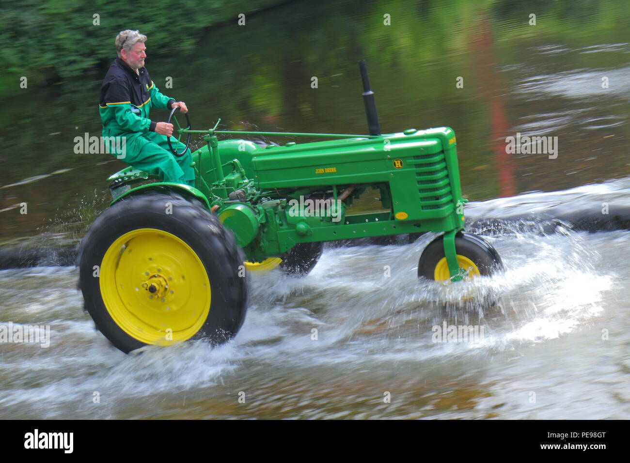 John deere tractor driving through water hi-res stock photography and ...