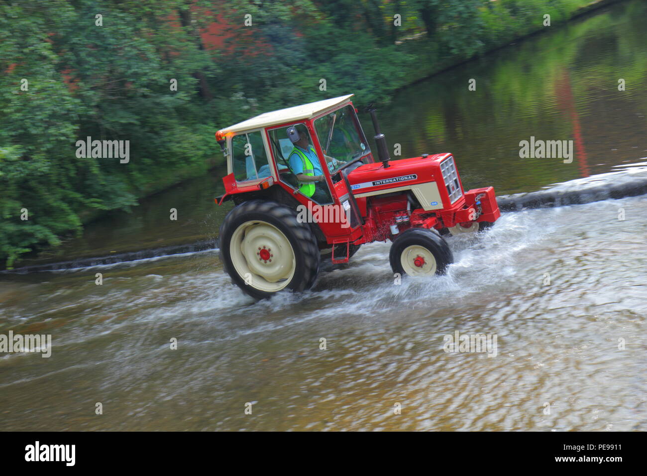 An International 574 tractor drives through the River Skell in Ripon ...