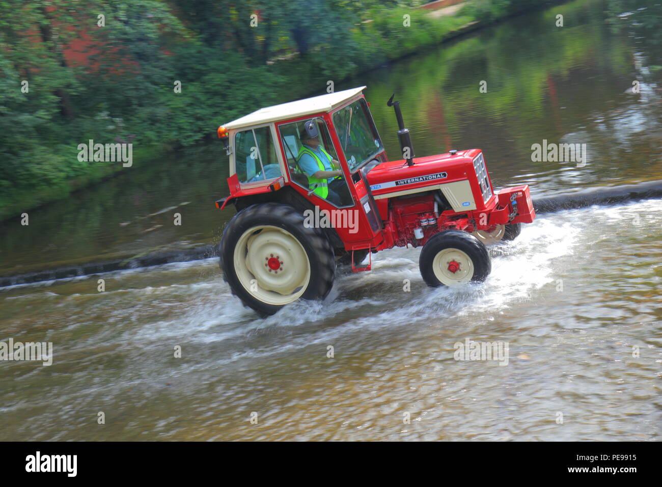 An International 574 tractor drives through the River Skell in Ripon ...
