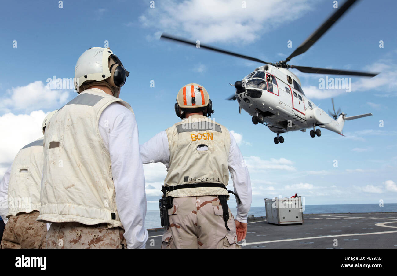 An SA330J Puma helicopter delivers pallets of cargo to the USS Oak Hill ...