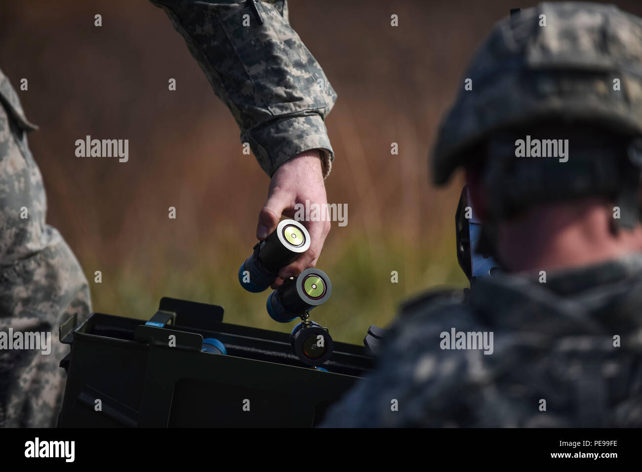 A U.S. Army Reserve military police Soldier holds up 40 mm flash ...