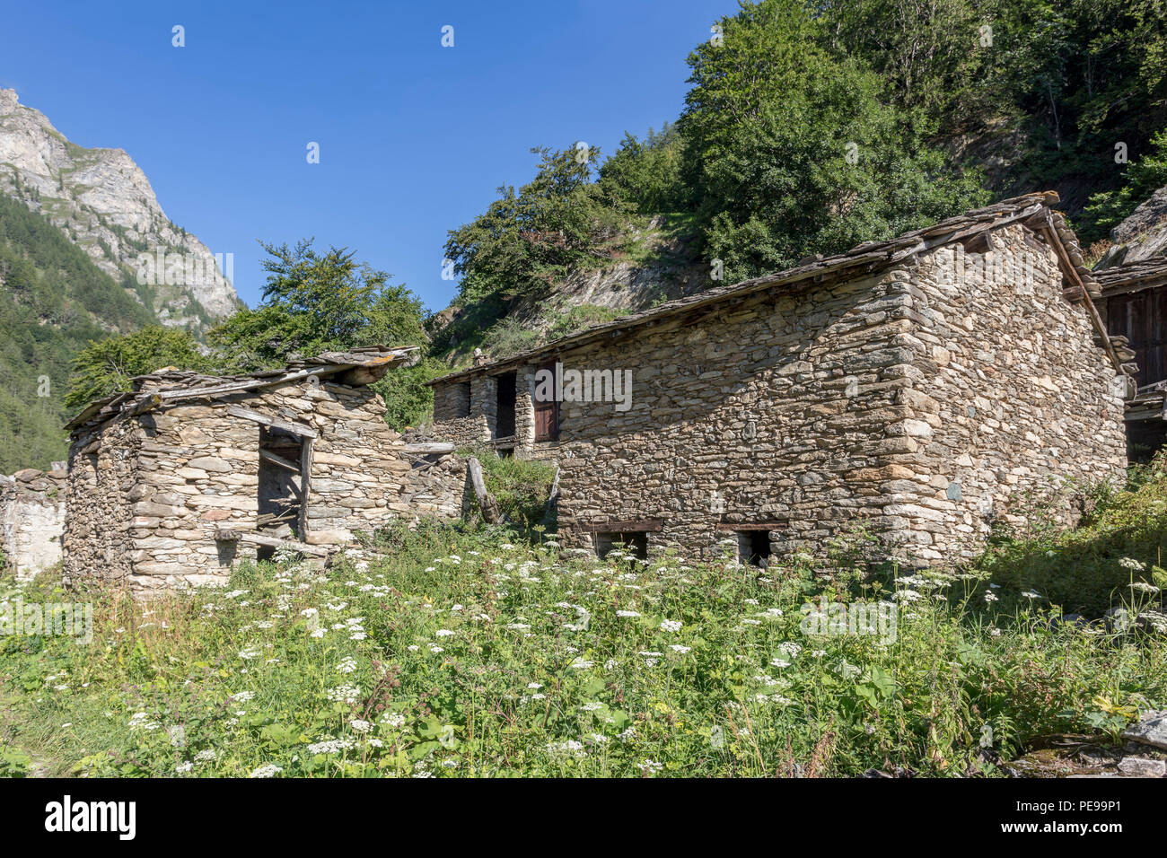 old and abandoned village in alps mountains full of different houses ...