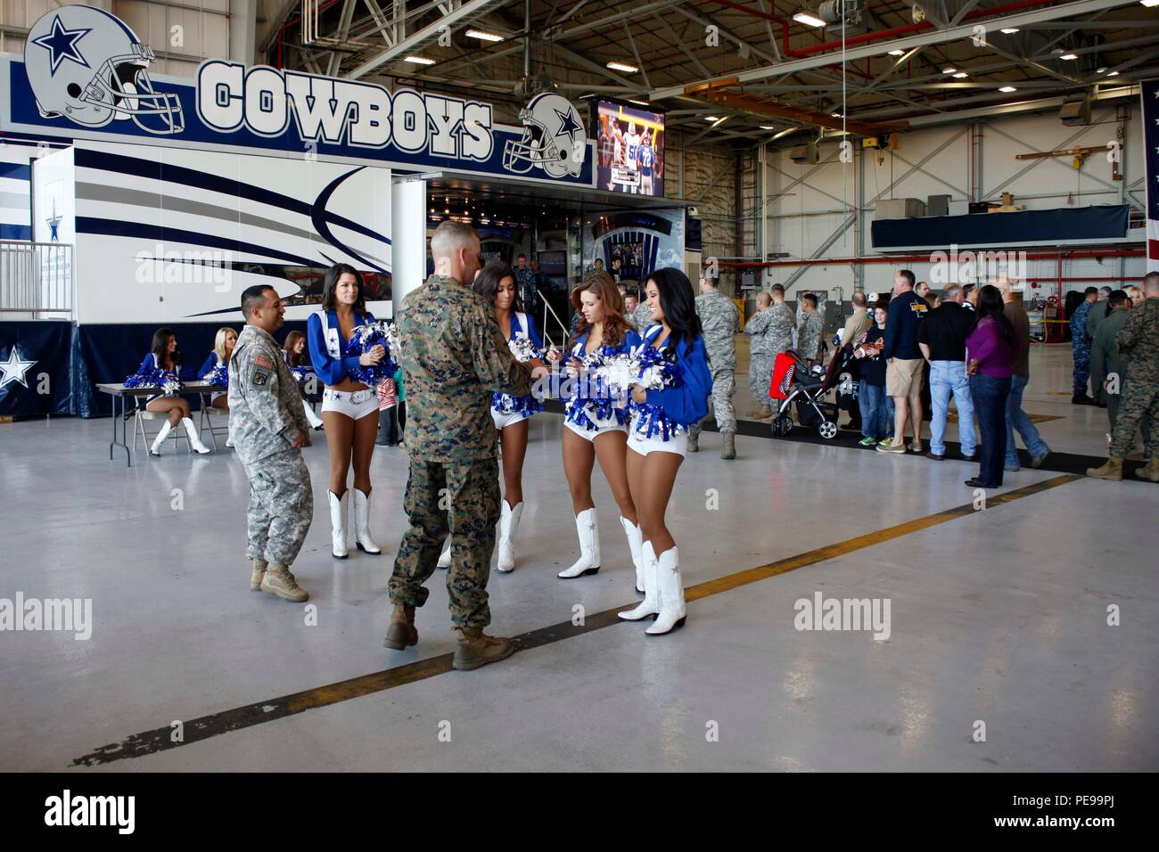 Cheerleaders from the Dallas Cowboys take pictures and sign autographs ...