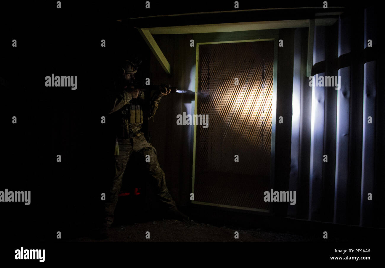 A U.S. Army soldier prepares to breach a building during a night ...