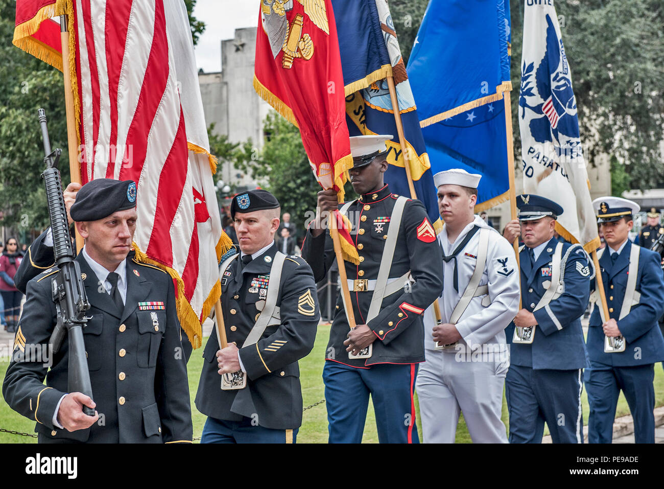 The Joint Base San Antonio color guard marches the American and joint ...