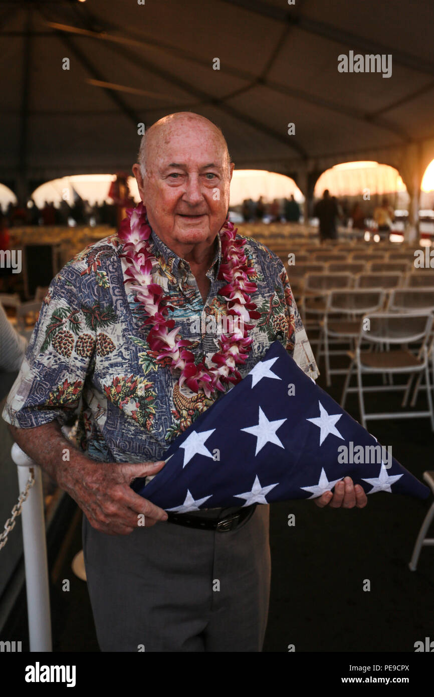 Retired Air Force Col. Jack Detour poses with the flag he received ...