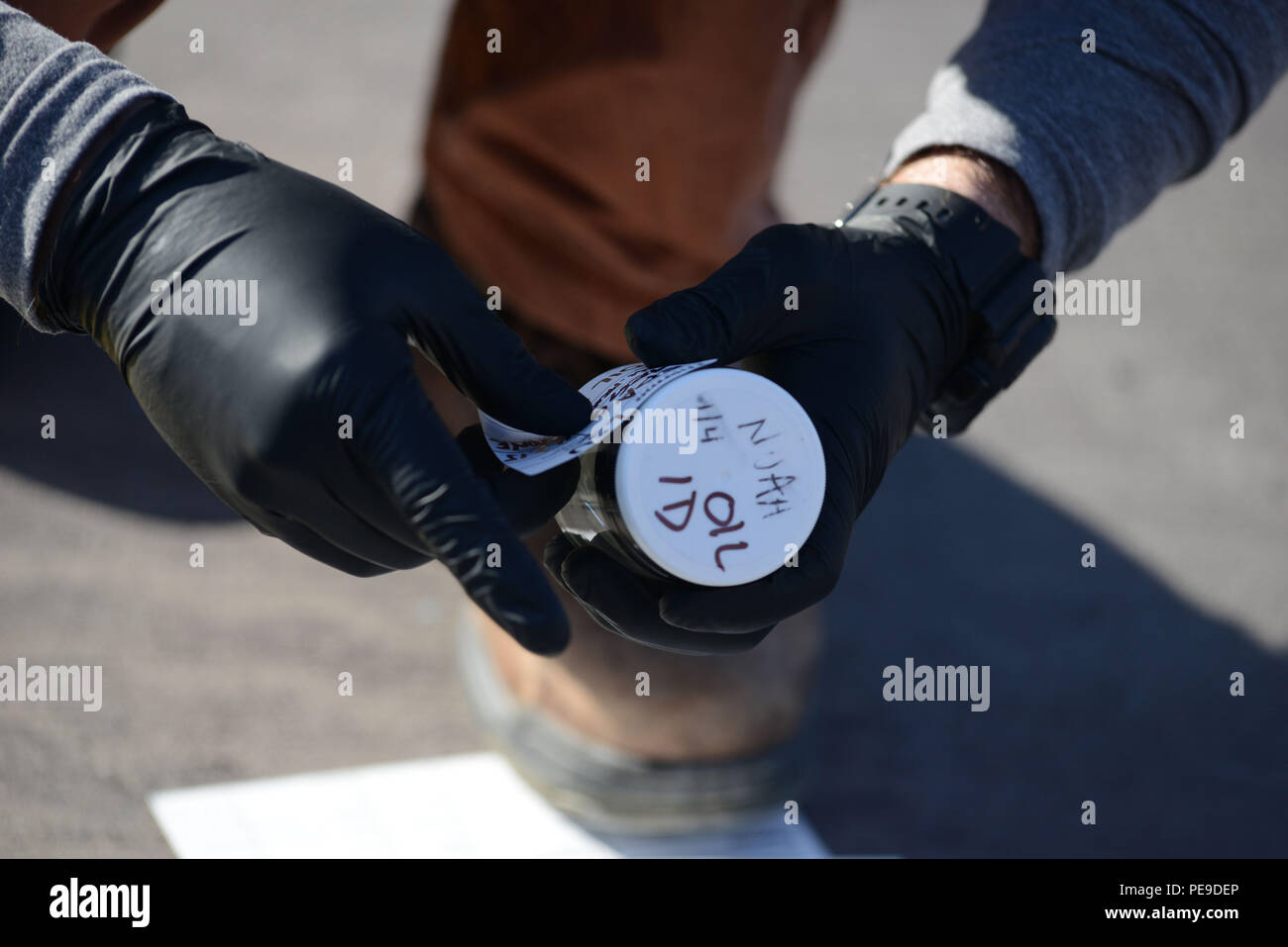 A responder labels a sample of product for analysis extracted from the ...