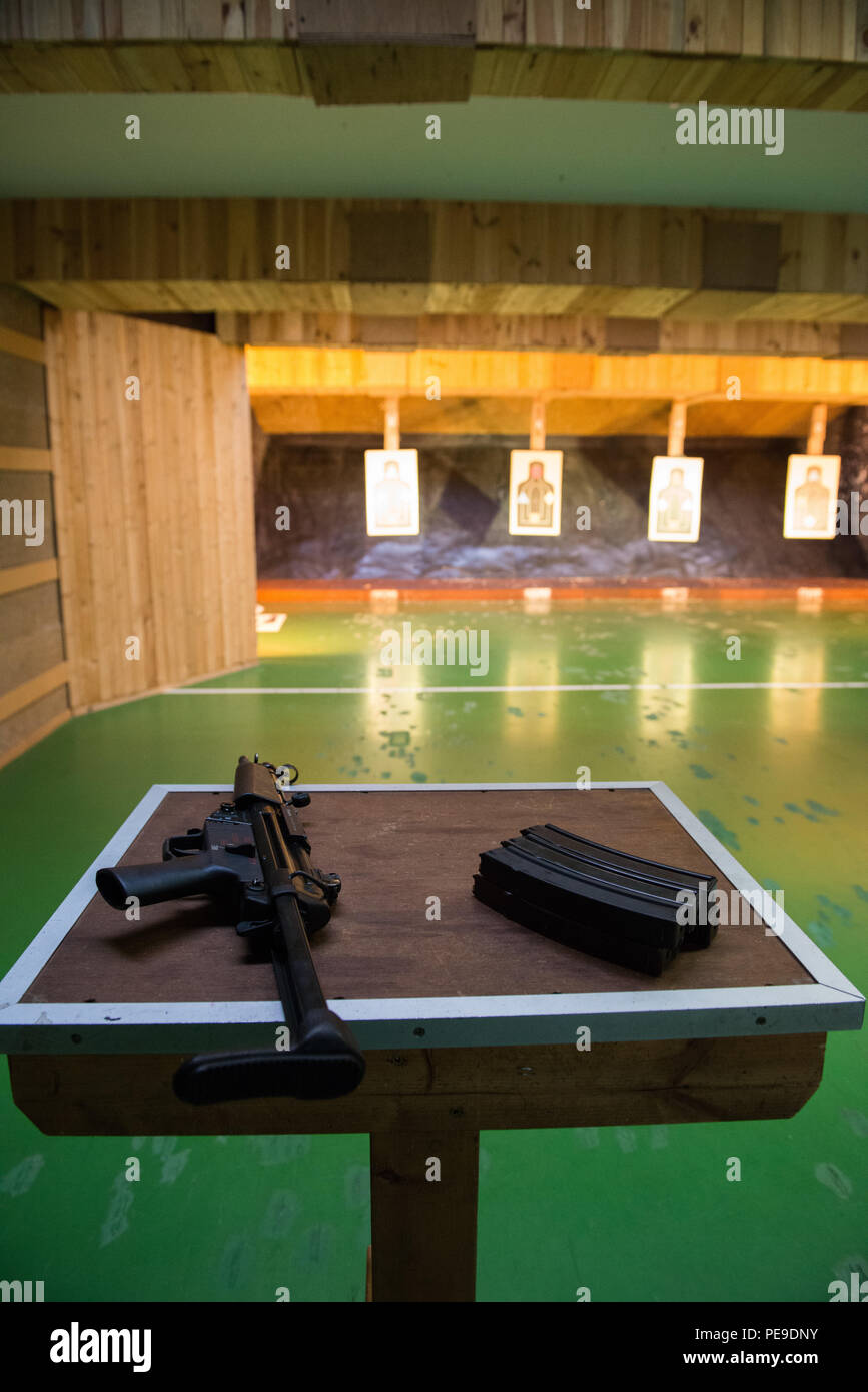 A Heckler & Koch MP5 submachine gun and magazine lay on a table in ...