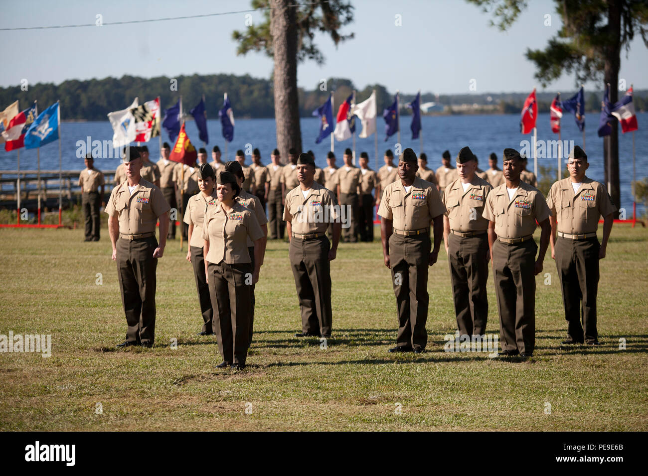 U.S. Marine Corps Maj. Lisa Arocho, center, stands at attention as ...
