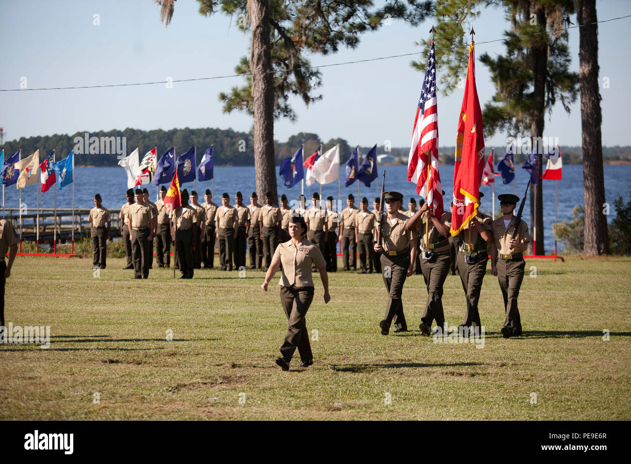 U.S. Marine Corps Maj. Lisa Arocho, center, marches the colors during ...
