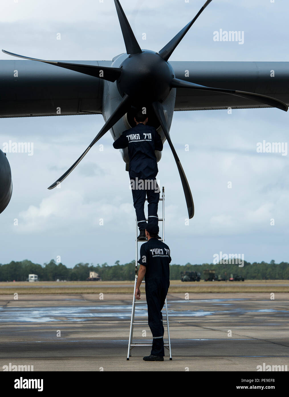 Members of the Israeli Air Force prep a C-130 Super Hercules for take ...