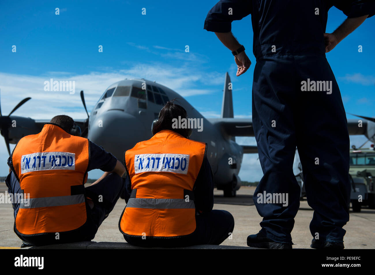 Members of the Israeli air force wait to prepare a C-130 Super Hercules ...