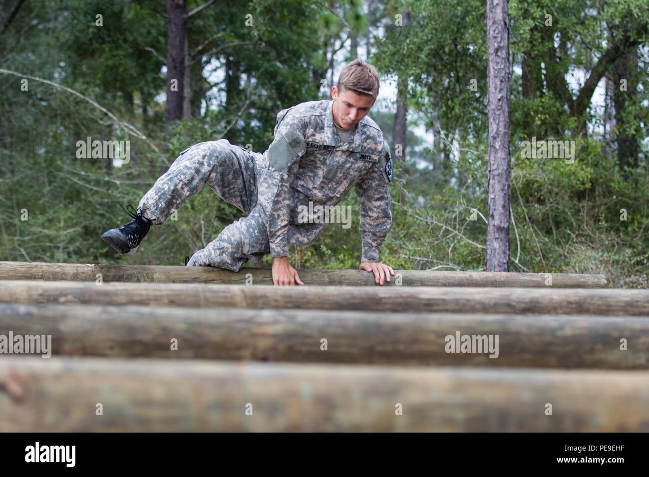 An Army Junior Officer Training Corps cadet navigates a log-hurdle ...