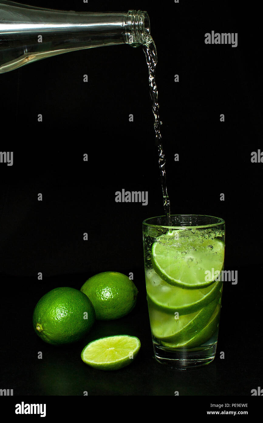 Summer refreshing and beverages concept. Stream of cold water from a ...