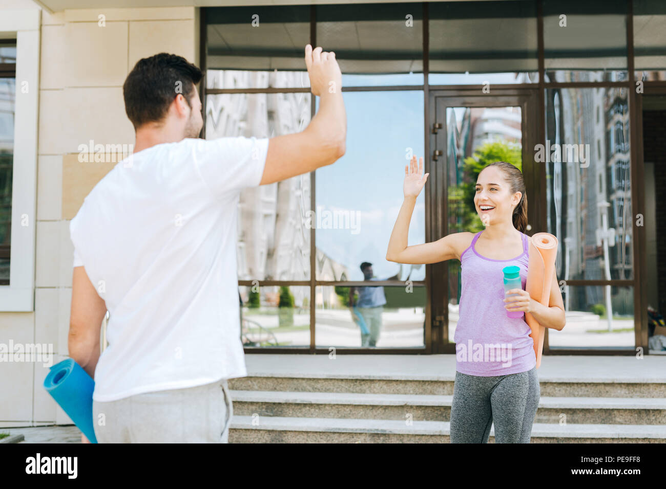 Joyful happy people greeting each other Stock Photo - Alamy