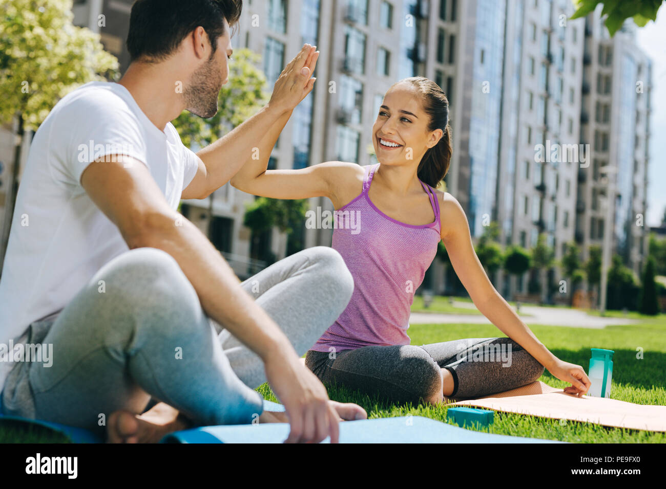 Delighted positive woman giving high five to her friend Stock Photo - Alamy