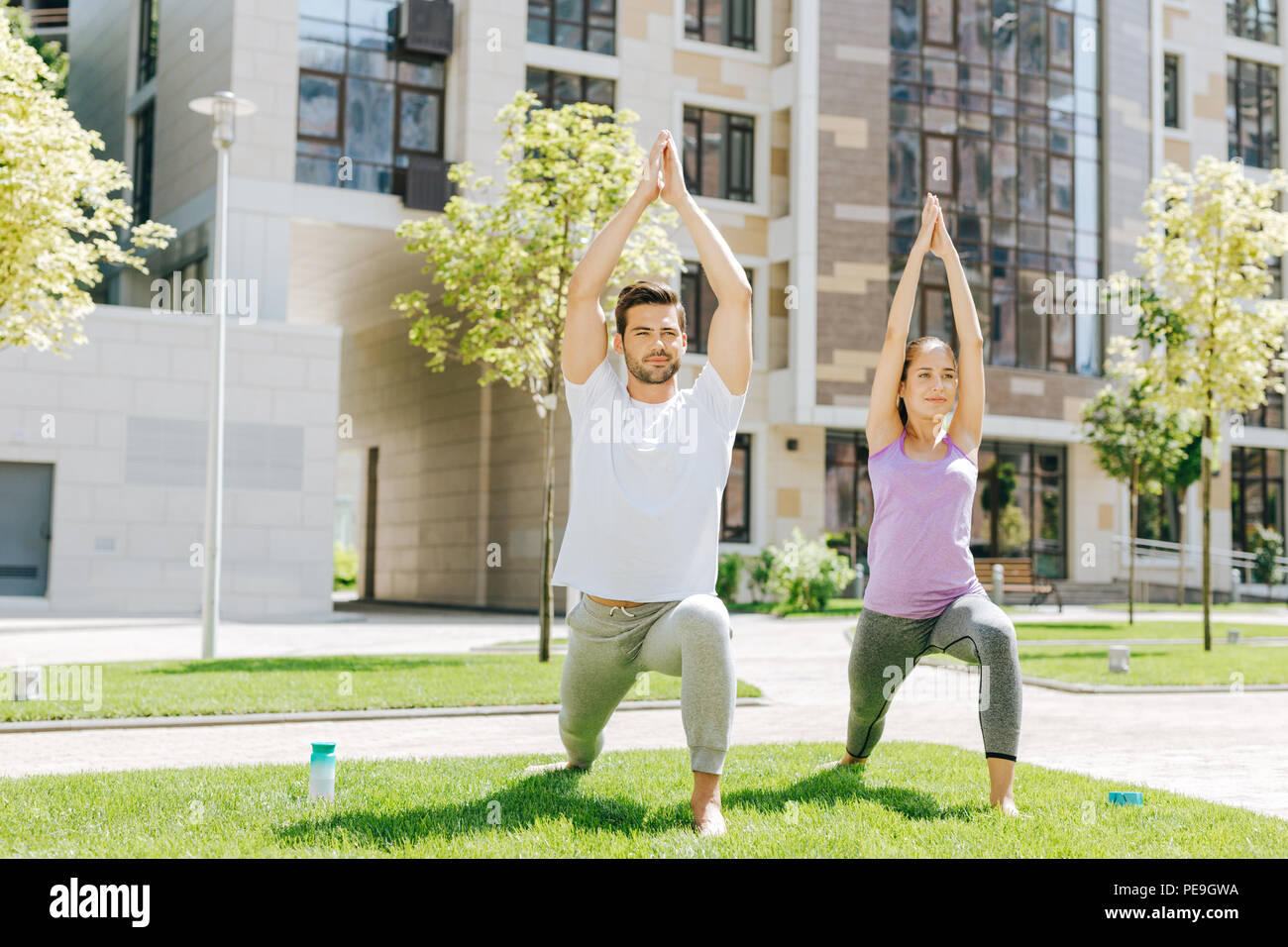Joyful sporty people doing sport exercises Stock Photo - Alamy