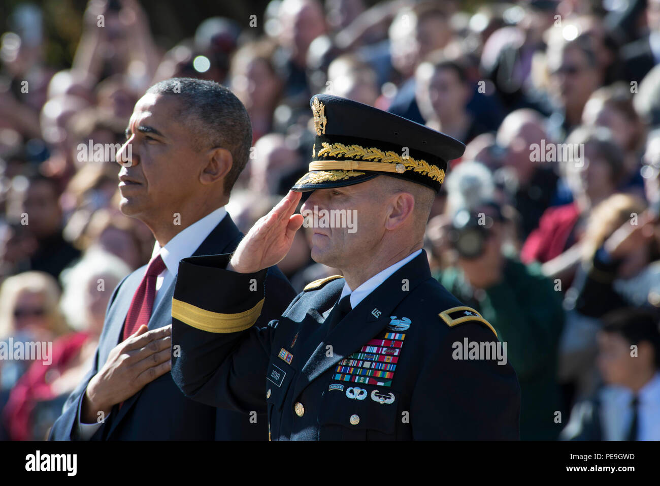President Barack Obama places his hand over his heart while U.S. Army ...