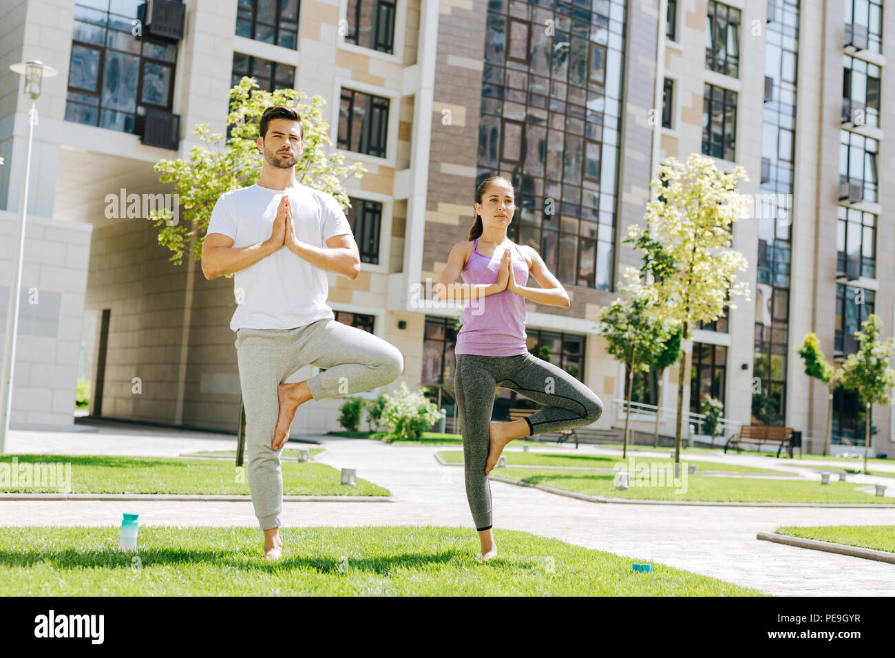 Positive healthy people standing on one leg Stock Photo - Alamy