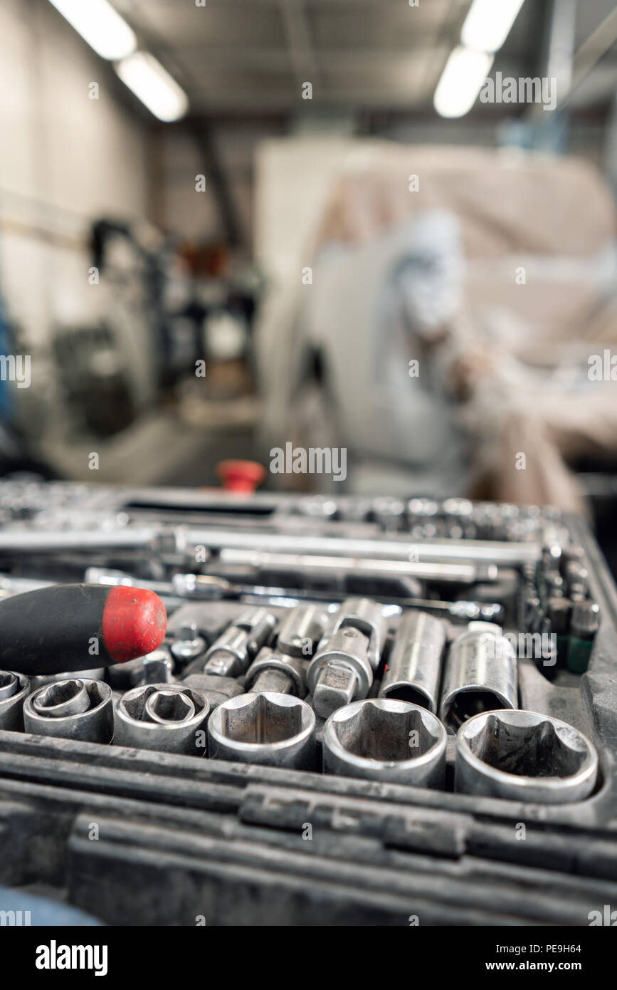 Dirty set of hand tools and wrenchs close-up in box. Garage painting ...