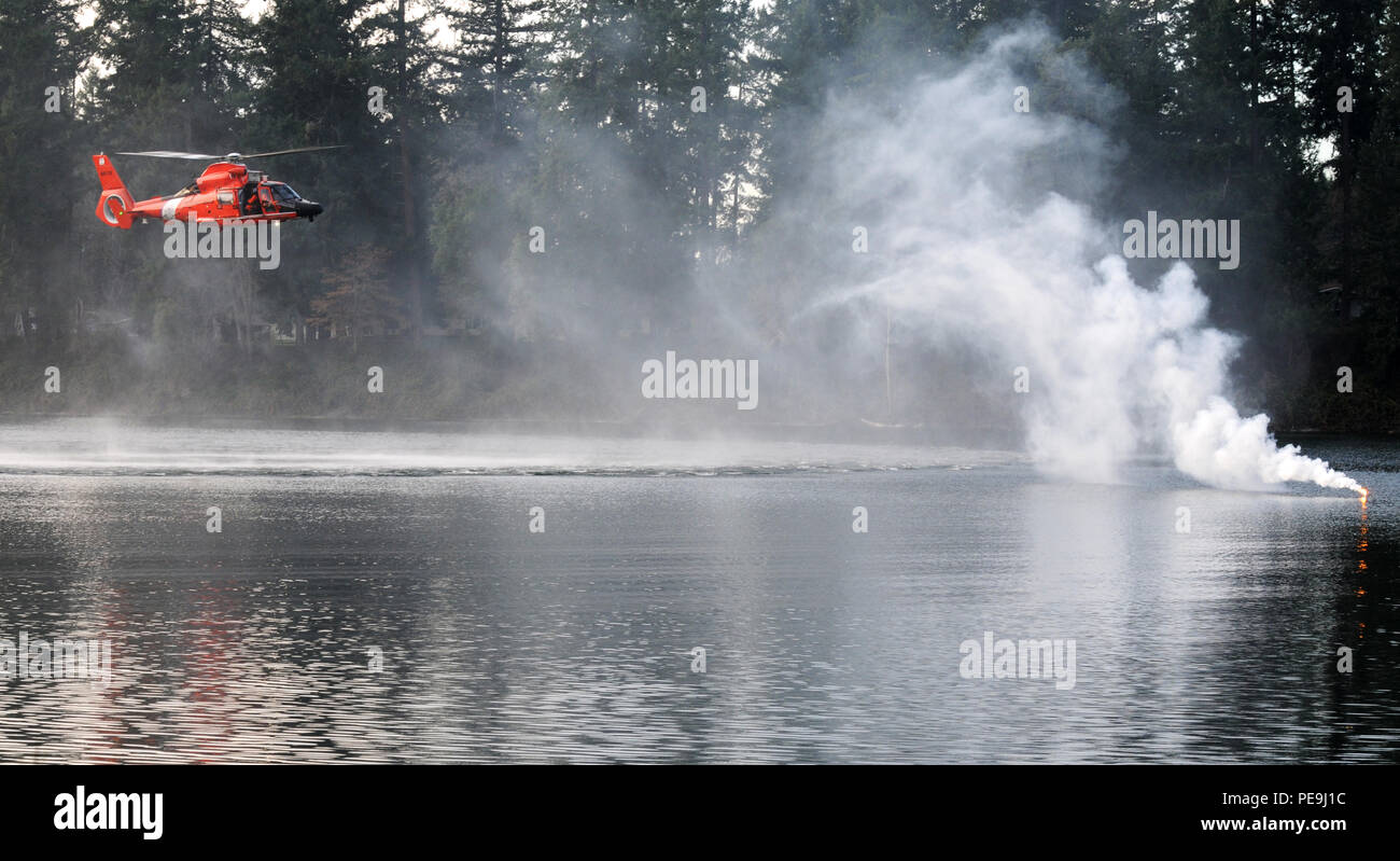 U.S. Coast Guardsmen approach a flare during extraction training as ...