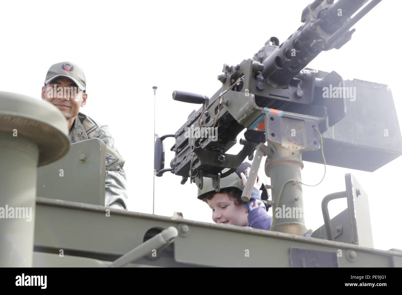 A Soldier from 1st Battalion, 509th Parachute Infantry Regiment assists ...