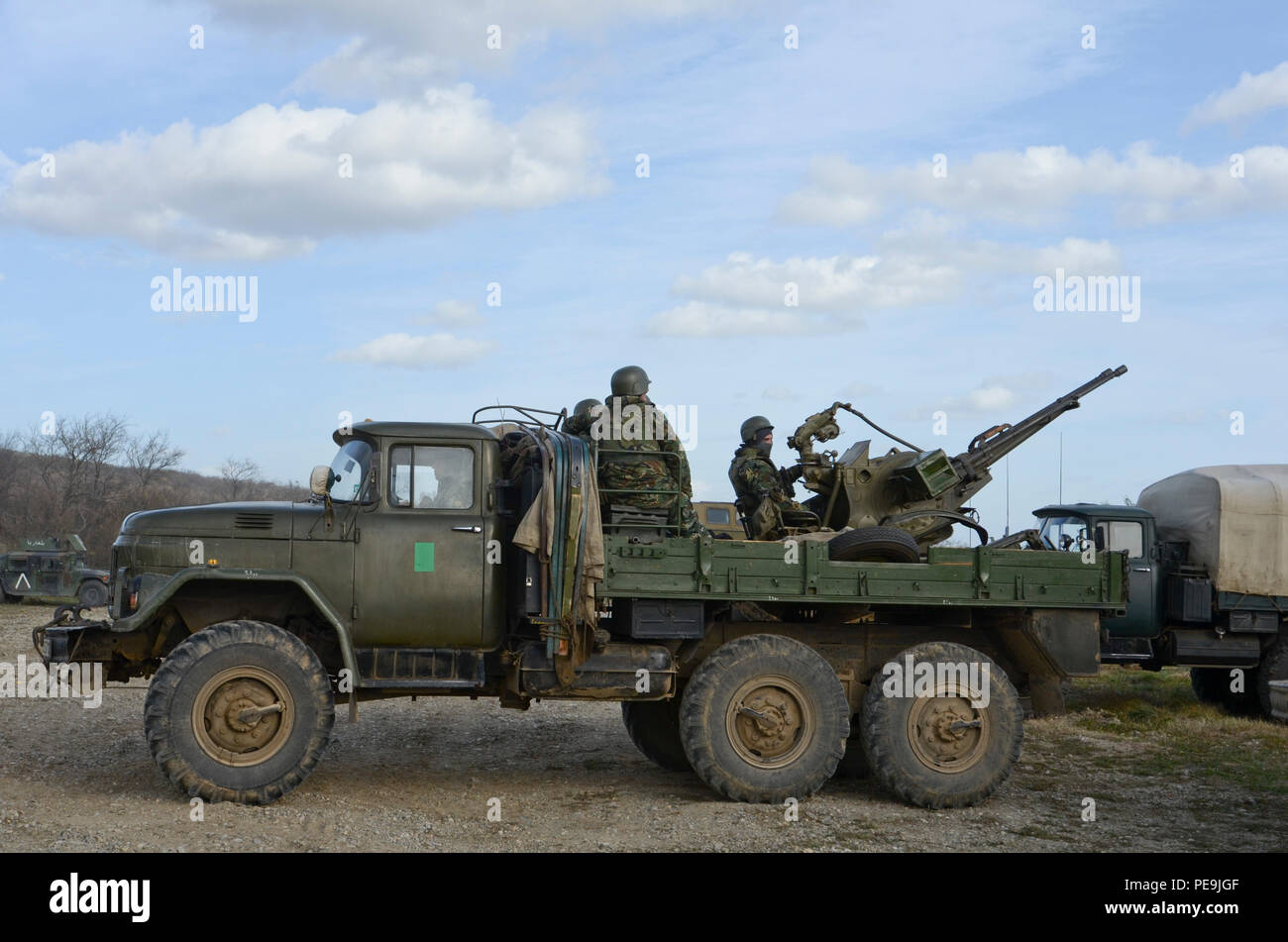 Bulgarian soldiers sit on the back of a truck with a ZU-23-2 during ...