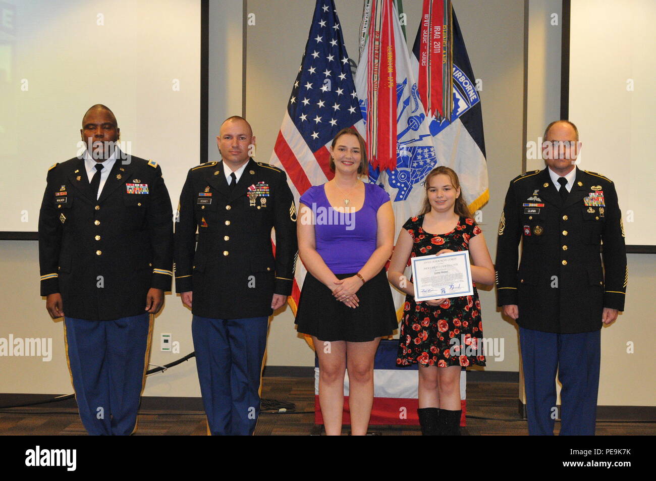 Retired Staff Sgt. Christopher L. Denney, his wife and daughter pose ...