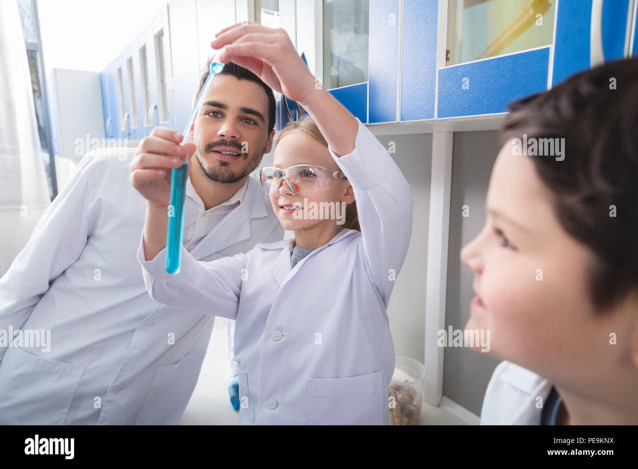 Super test. Handsome man observing when pretty little pleasant girl ...