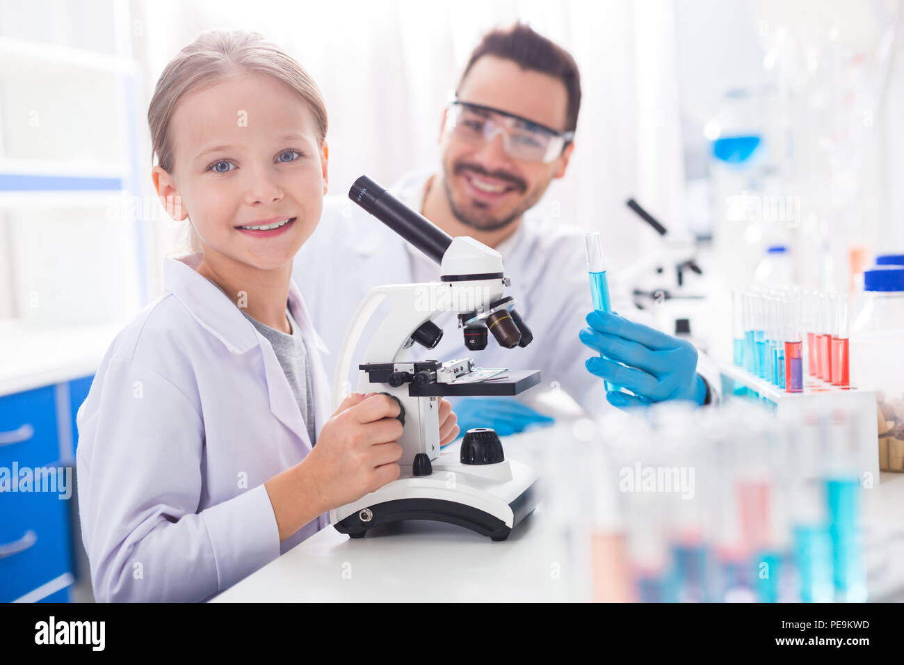 Exciting observation. Cheerful happy positive girl grinning while ...