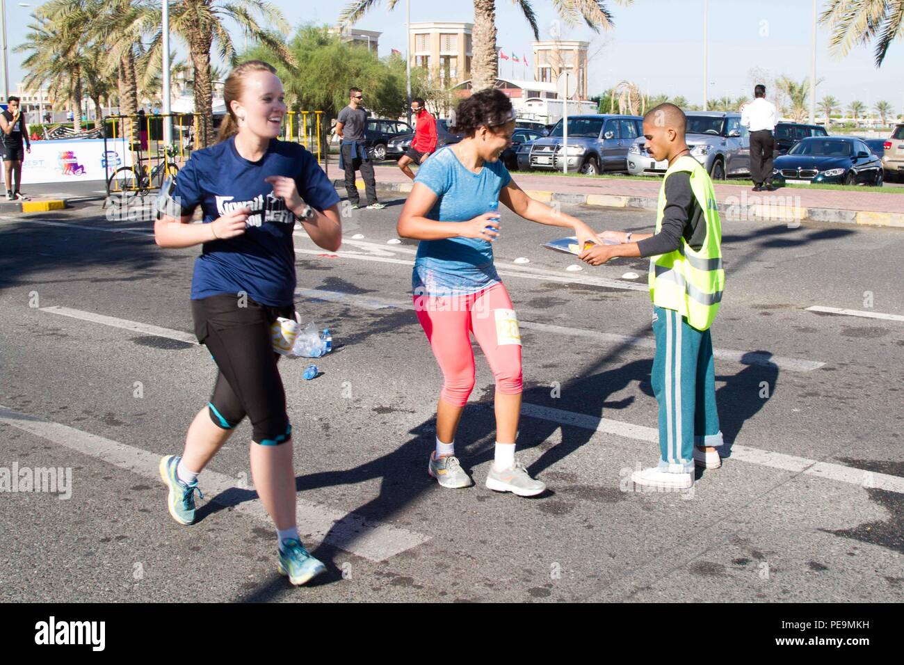 Capt. Kelsey Fiddles (left), a branch chief with Area Support Group ...