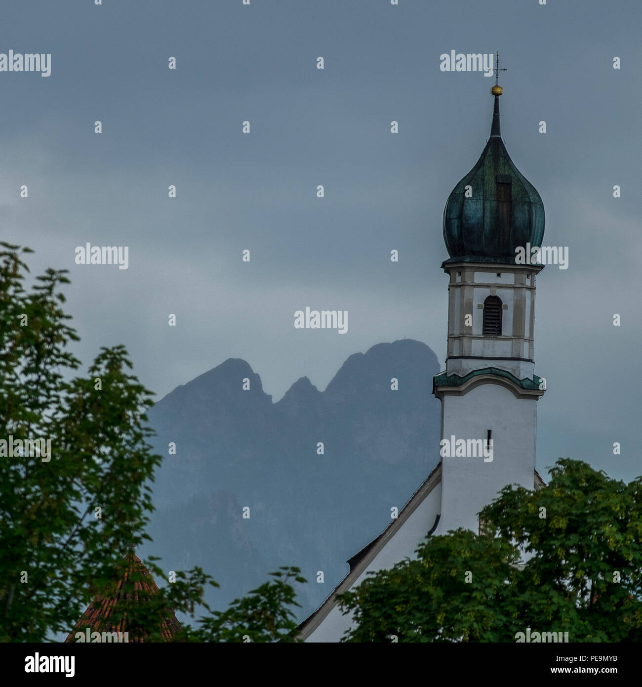 church & mountains at fussen, bavaria, germany Stock Photo - Alamy