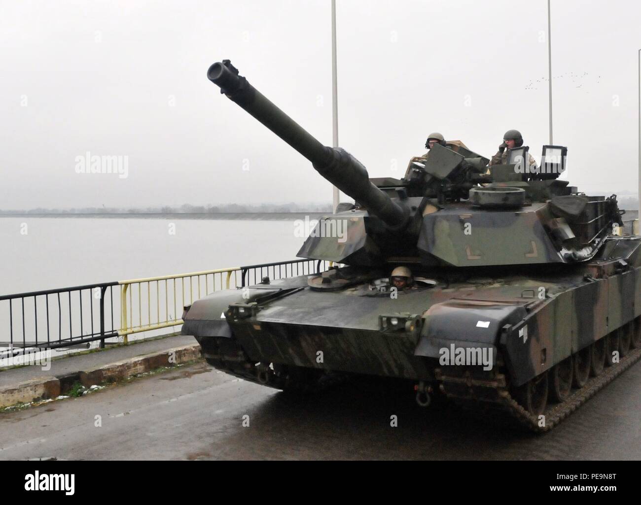 An M1A2 Abrams is driven over a dam in Cincu, Romania, on Nov. 24, 2015 ...