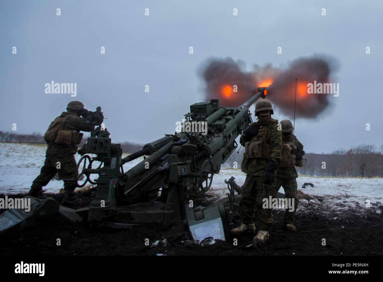 U.S. Marines with Kilo Battery, 3rd Battalion, 11th Marines, fire a ...