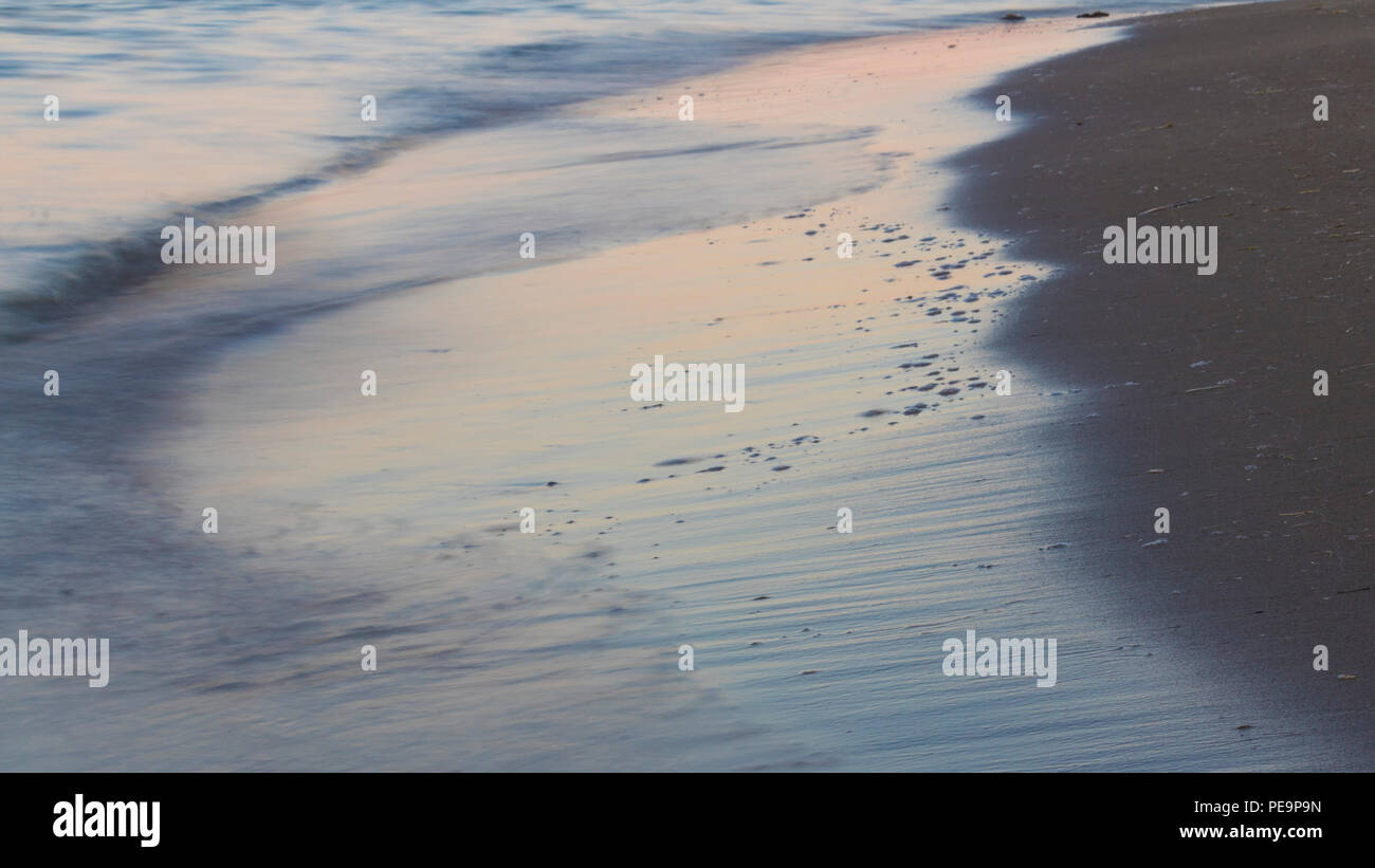 Beautiful sunset reflected on italian sea waves Stock Photo - Alamy
