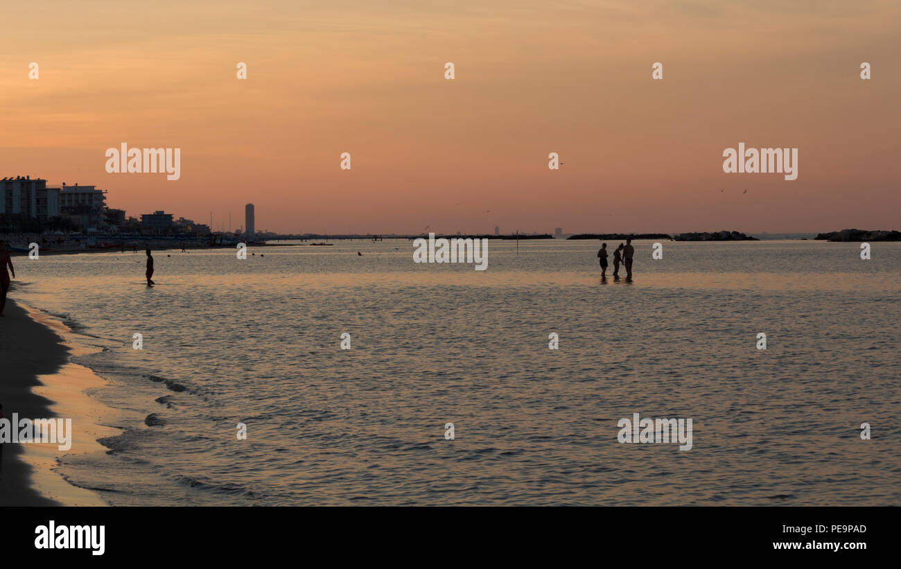 Colorful sunset reflected on water beach, italy Stock Photo - Alamy