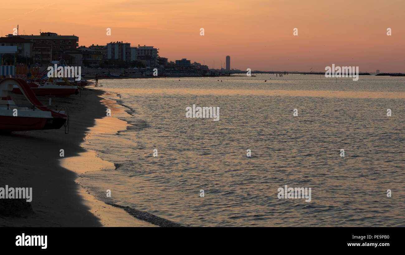 Colorful sunset reflected on water beach, italy Stock Photo - Alamy