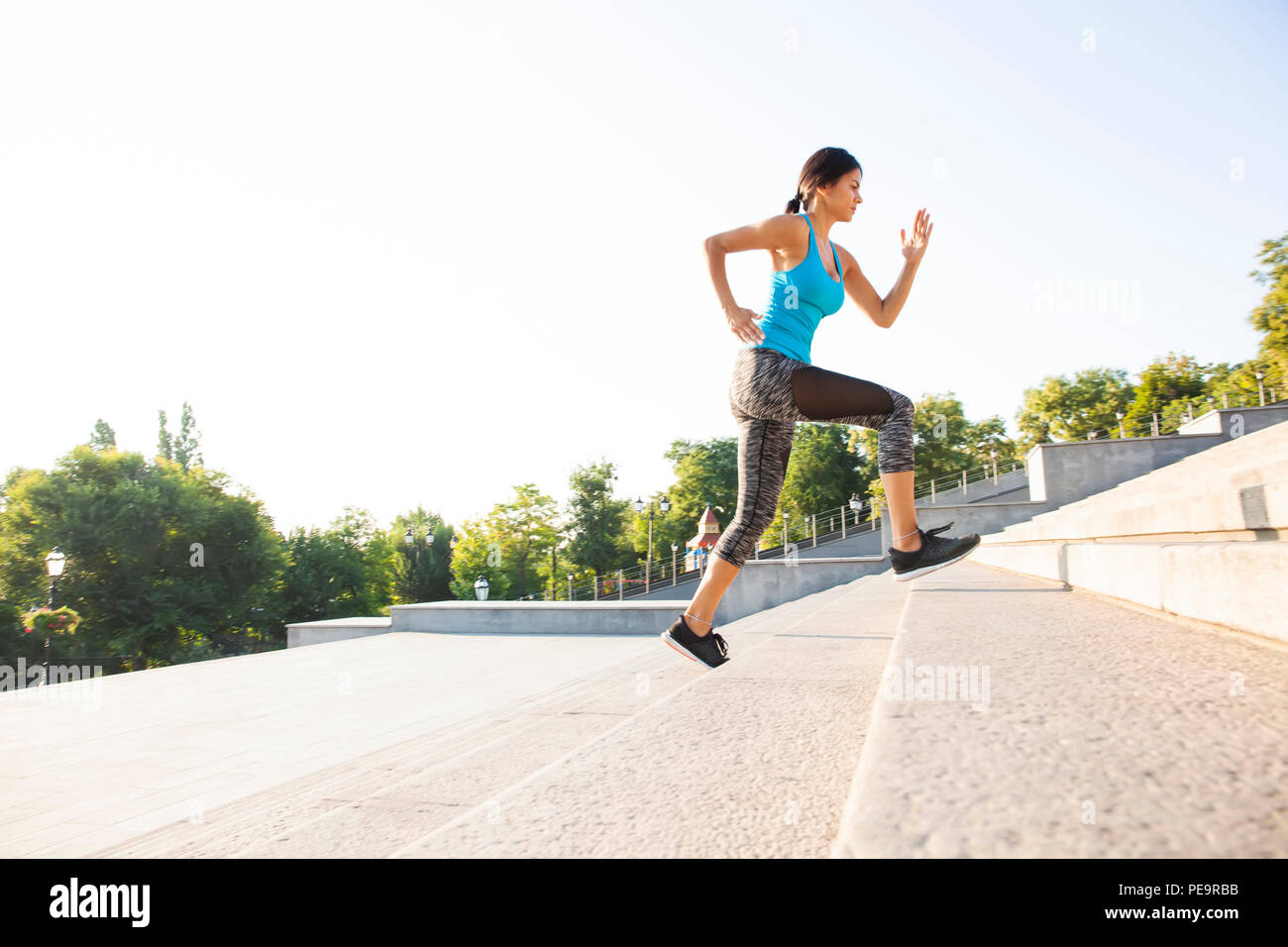Runner athlete running on stairs. woman fitness jogging workout ...