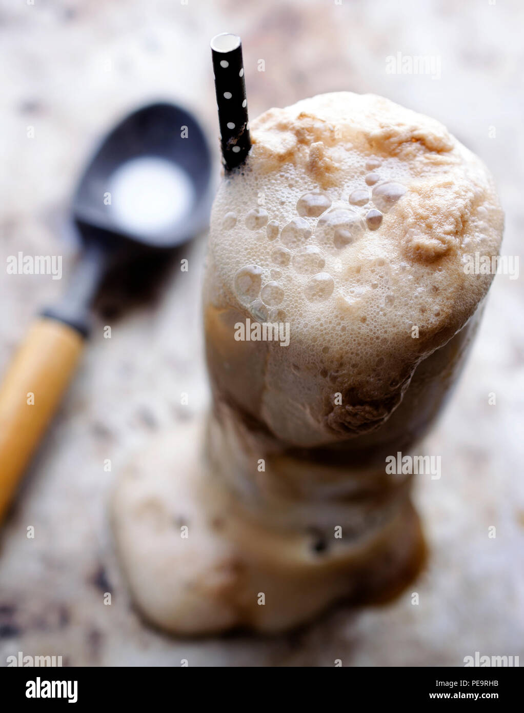 Close up photograph of an overflowing, messy ice cream float. A vintage ...