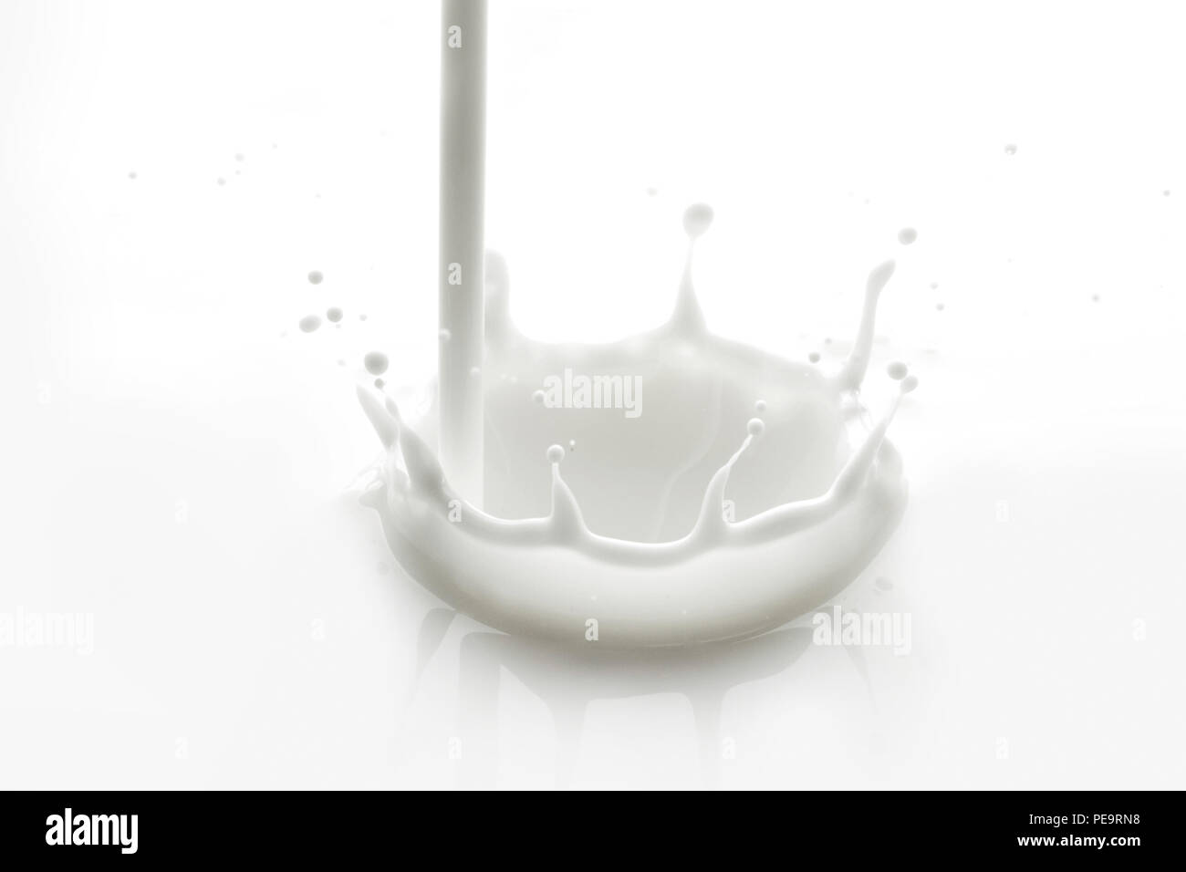 Pouring milk splash close-up on white background Stock Photo - Alamy