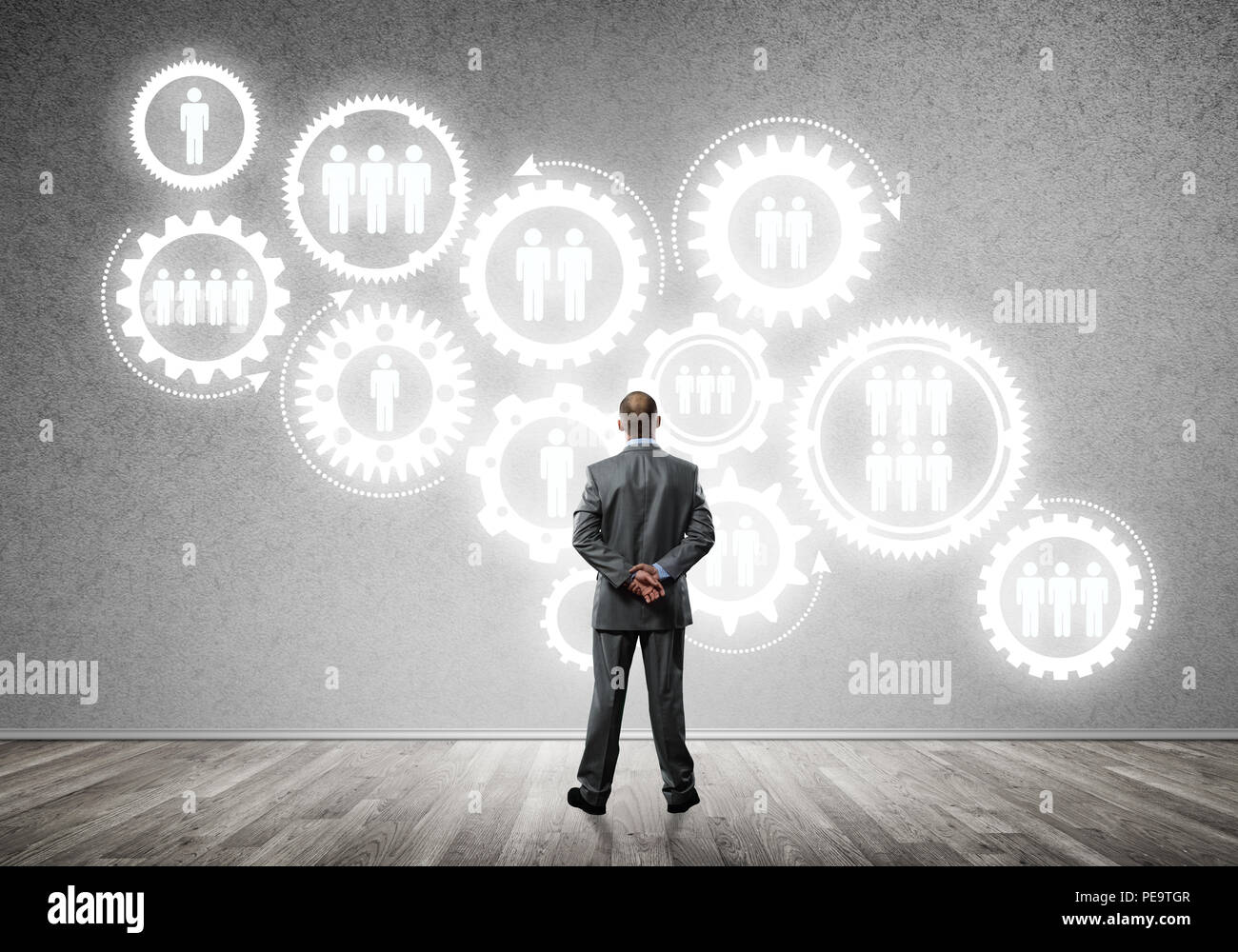 Cogwheel engine drawn on concrete wall as symbol for teamwork and ...