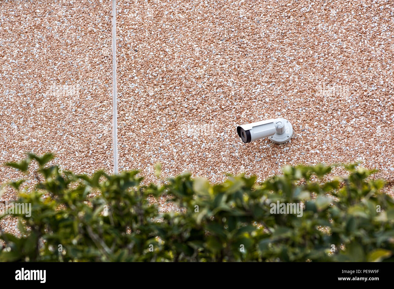 Outdoor bullet CCTV camera on the wall, space for text. Concept ...