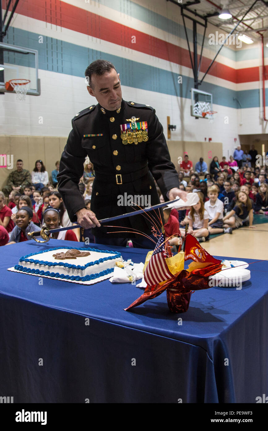 Lt. Col. Joshua A. Riggs cleans his sword during a cake cutting ...