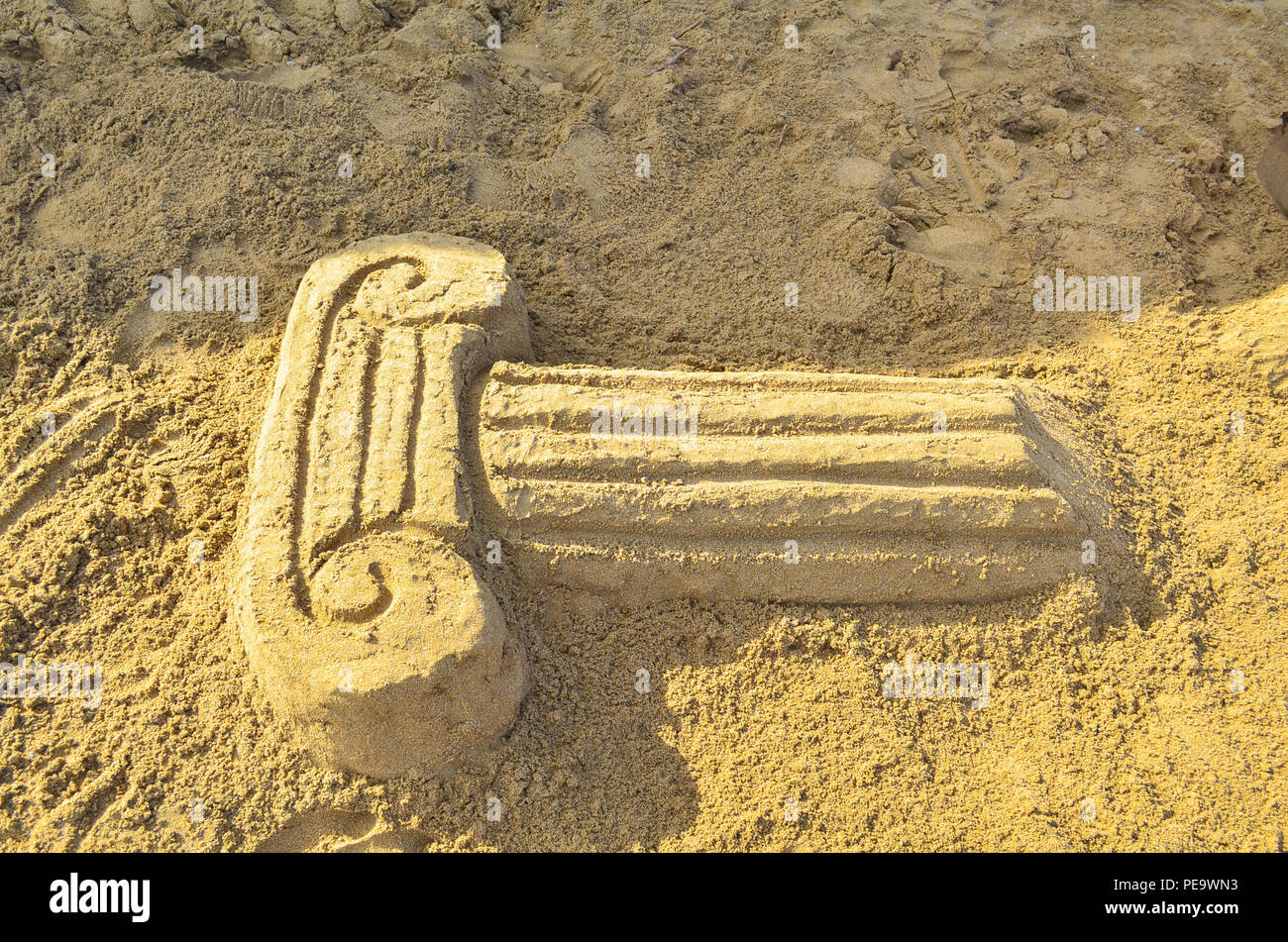 Sand sculpture in the form of an antique column on the beach Stock ...