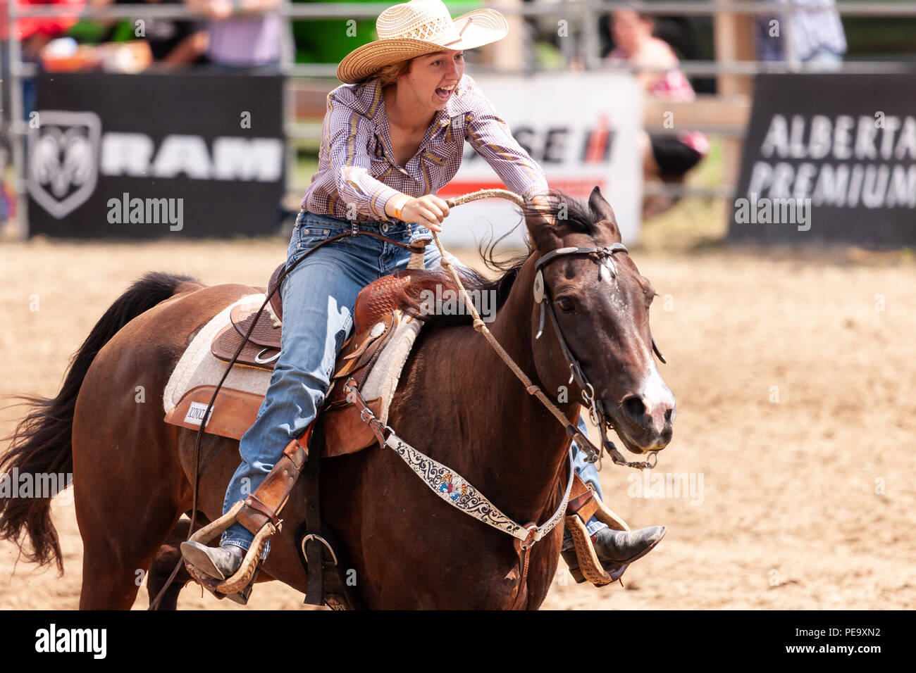 Cowgirls guide their quarterhorses through the Pole Bending course ...