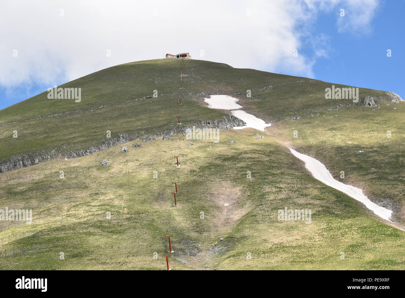 Mountain view with building on top and snow Stock Photo - Alamy
