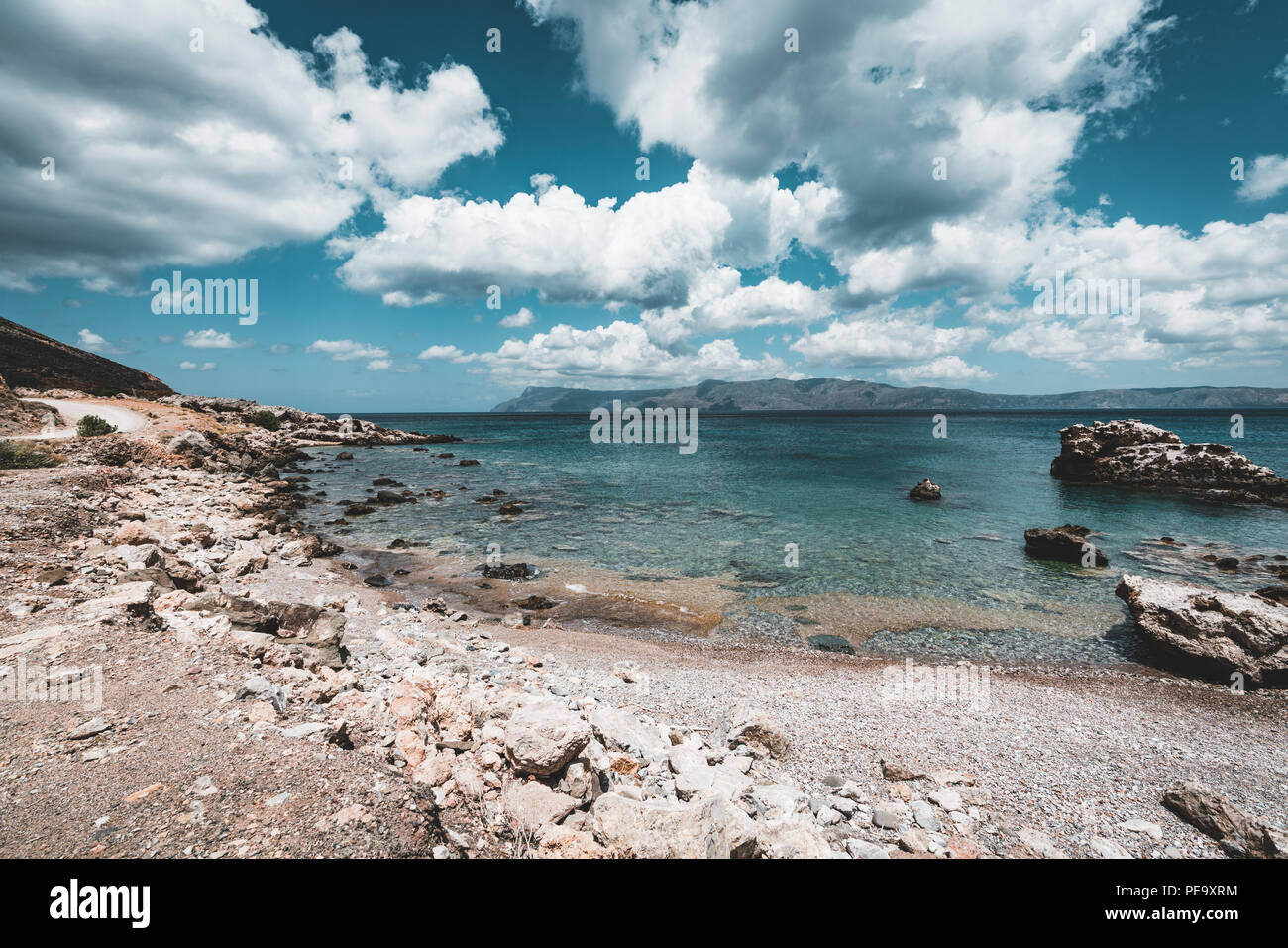 Panoramic view of rocks and beach with sky and clouds in Crete, Greece ...