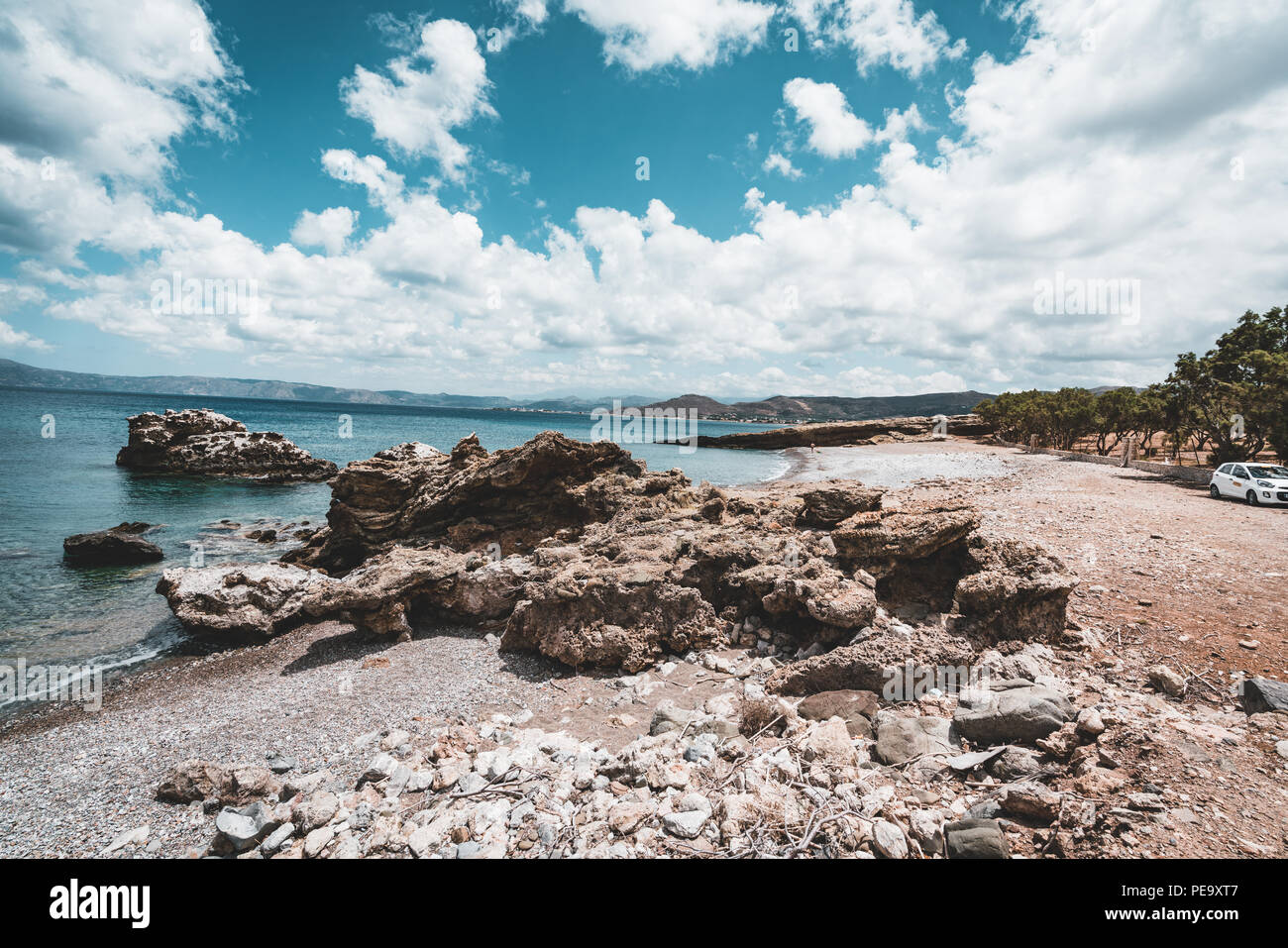 Panoramic view of rocks and beach with sky and clouds in Crete, Greece ...